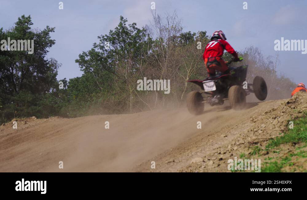 Quad bike riders jump over a hill during tournament. Extreme sports ...