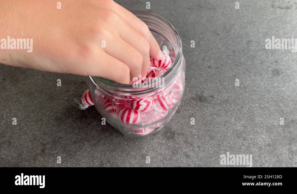 Kid hand takes candy out of a glass jar and then takes entire jar Stock ...