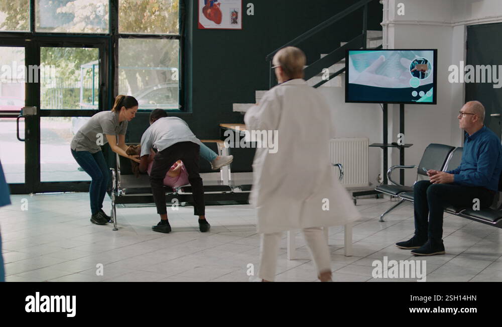 Father carrying unconscious kid in facility lobby to receive help Stock ...