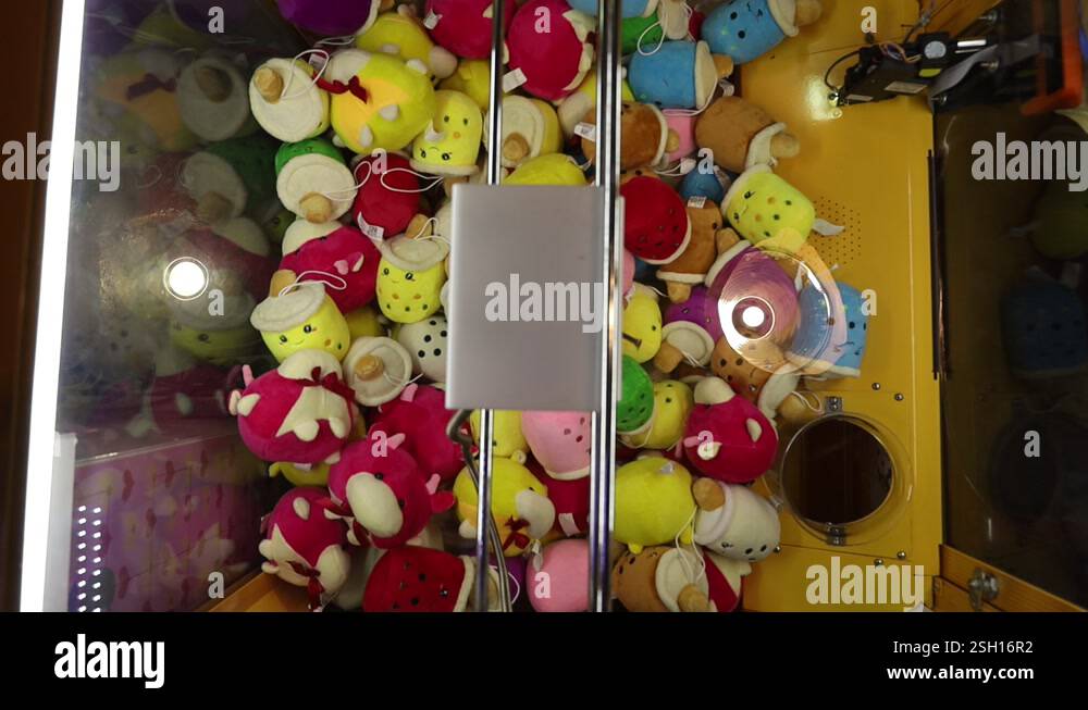 Grabber machine with lovely dolls inside. Amuse dolls in crane claw ...