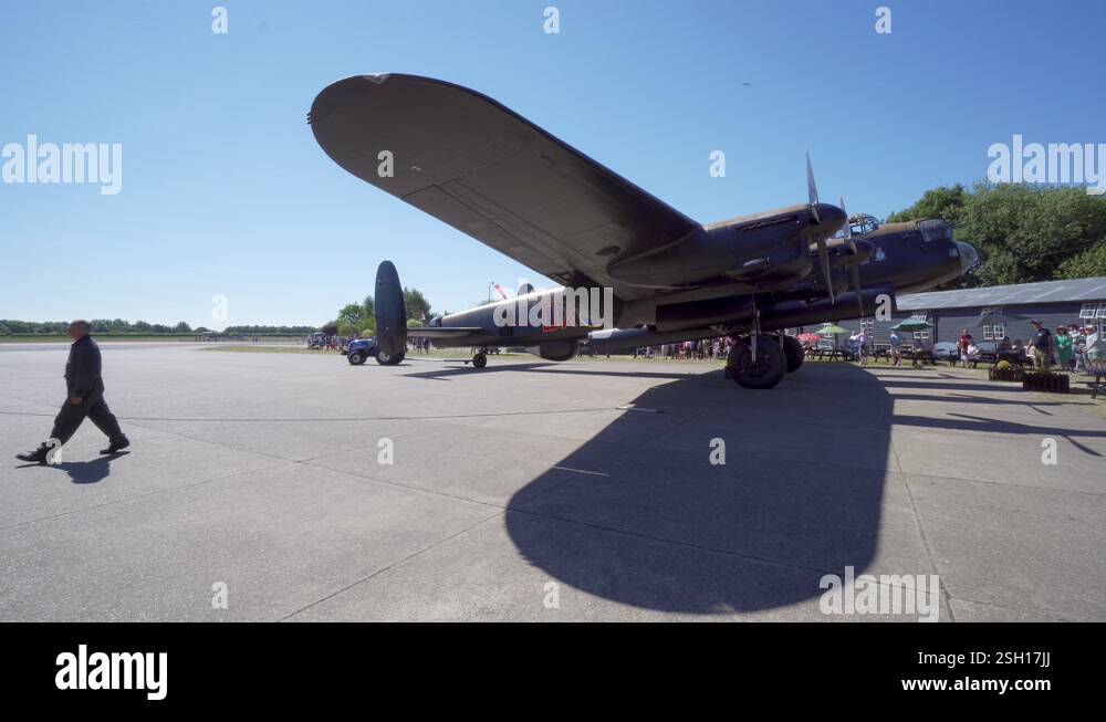 Video footage of a Lincoln Bomber Aeroplane been moved around a runway ...