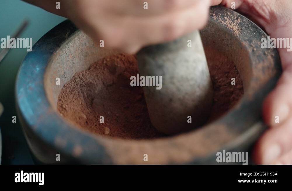 Сlose-Up Of A Stone Mortar And Pestle grinding red sand red clay Stock ...