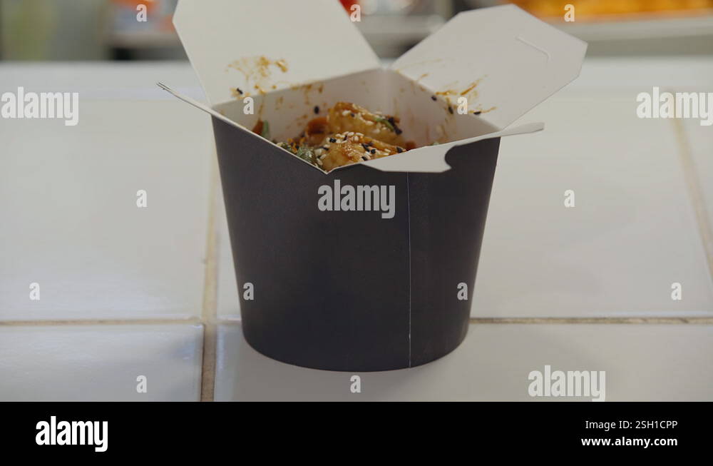 Close-up of a cardboard box filled up with the chinese food in the cafe ...