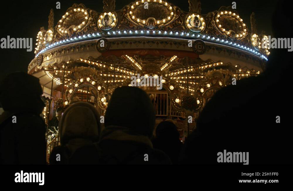 christmas carousel, people walk on foreground Stock Video Footage - Alamy