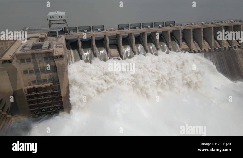 Low aerial approaches hydro dam releasing tons of water during flood ...