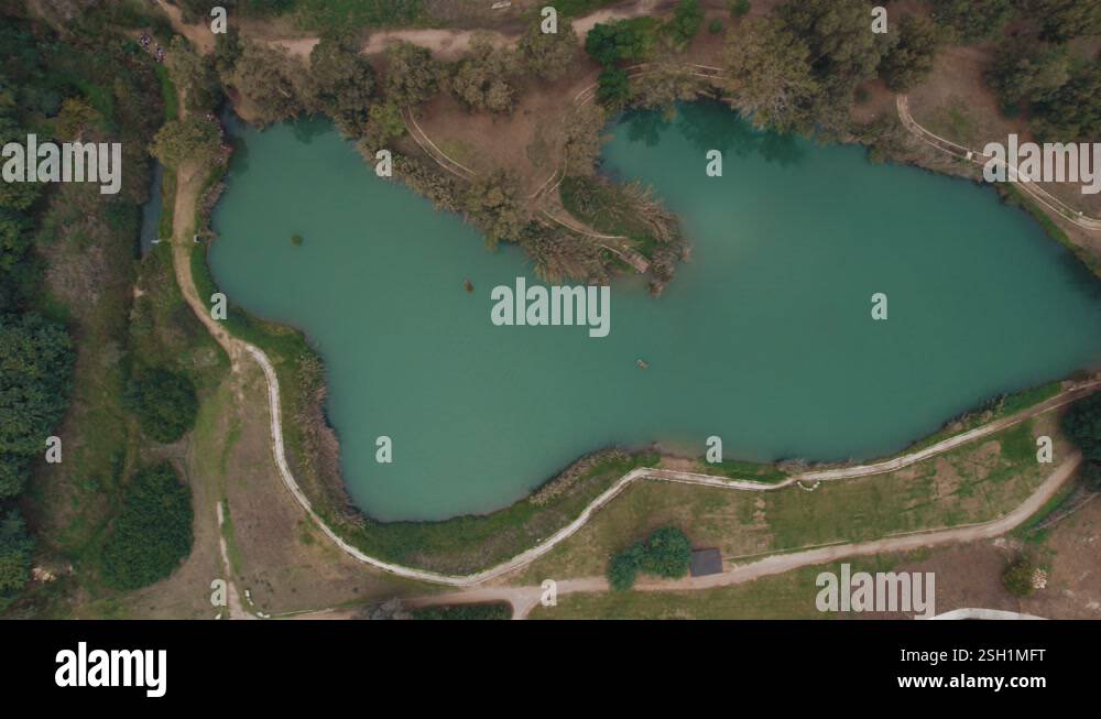 Aerial tilt down slide over a beautiful lake in Tel Afek National Park ...