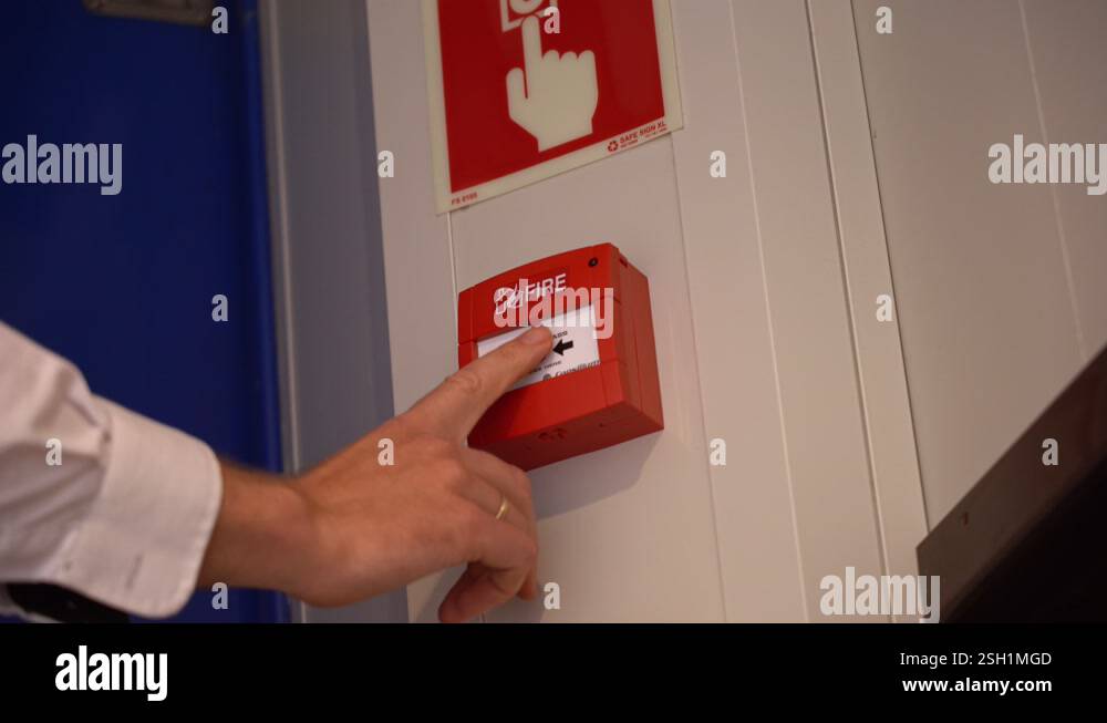 Ships crew showing how to release fire alarm onboard ship - Low angle ...