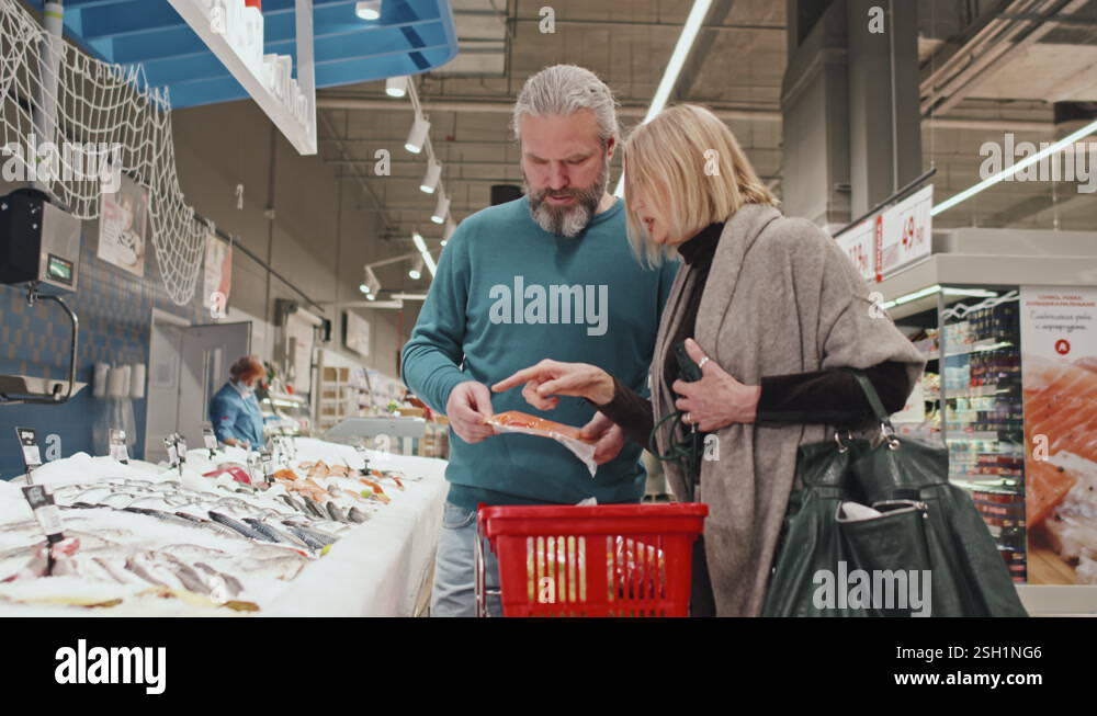 Mid Adult Couple Choosing and Buying Fish in Supermarket Stock Video ...