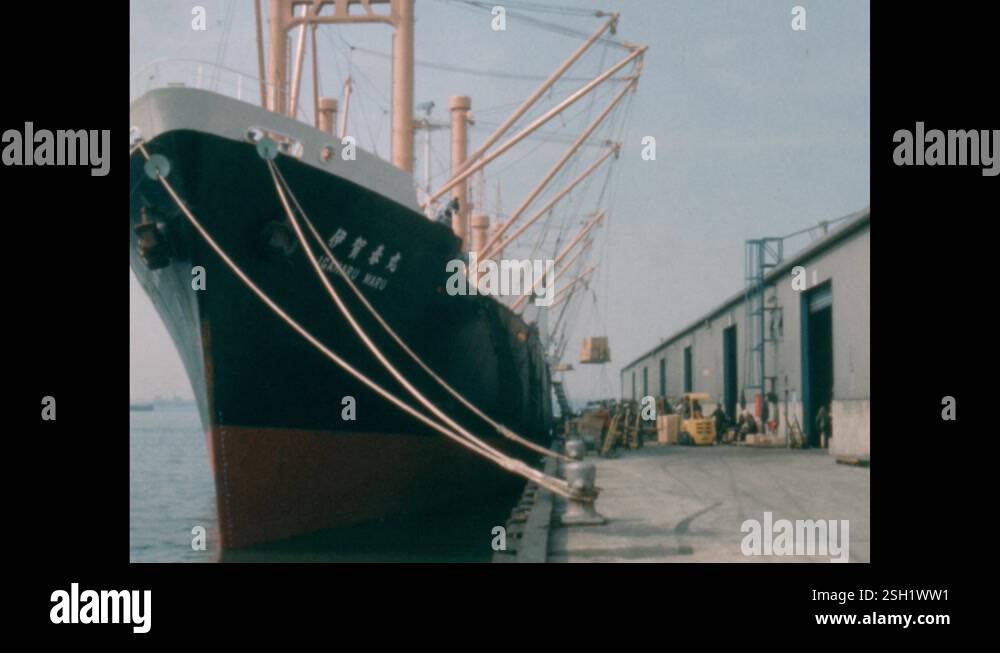 1960s: Crane unloads pallets of boxes from a Japanese cargo ship to a ...