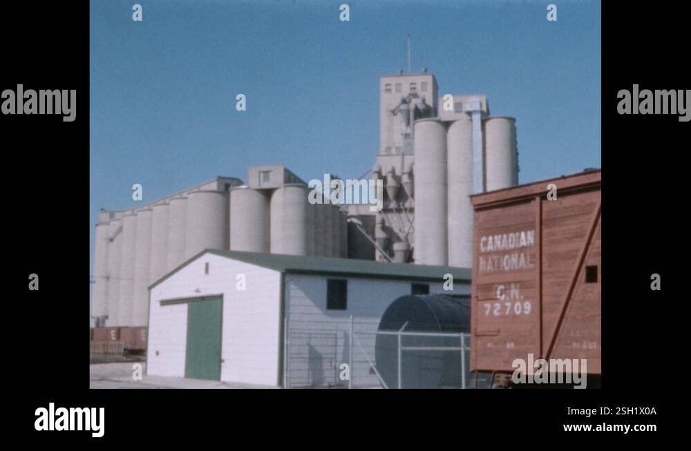 1950s: Industrial facility with large cylindrical buildings. Truck ...