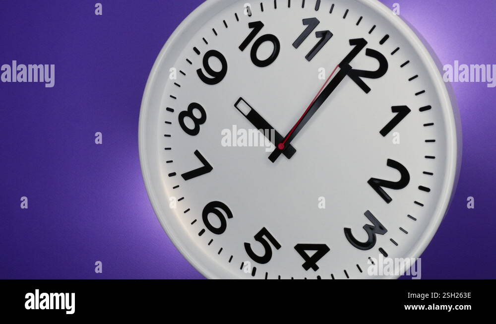 A White Wall Clock On Purple Background With A Time Of 9.00 Am Or Pm. A ...