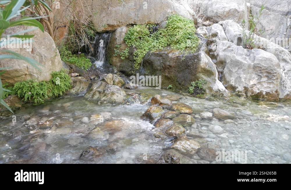 Spring water pouring from between the rock at Fonts de LAlgar, Alicante ...