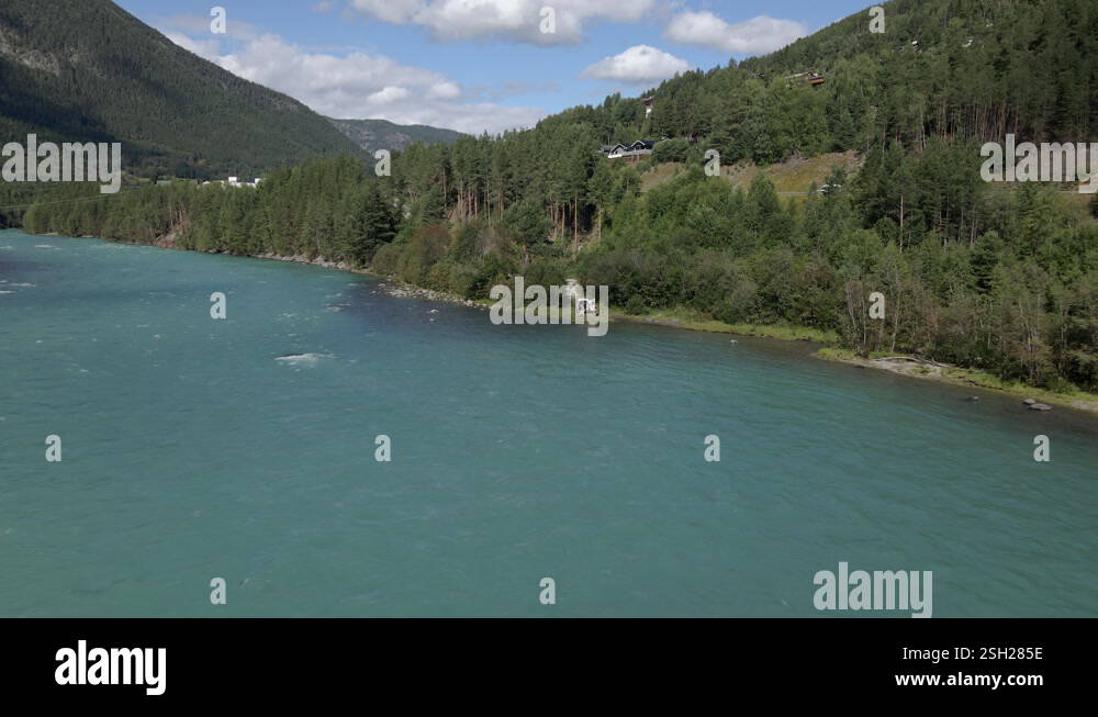 Aerial drone backward moving shot over Otta river in Lom, Norway on a ...
