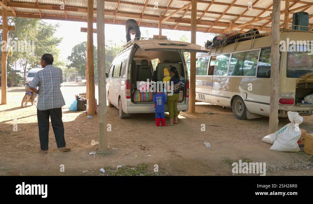 Asian family packing their luggage into a mini van for a trip Stock ...