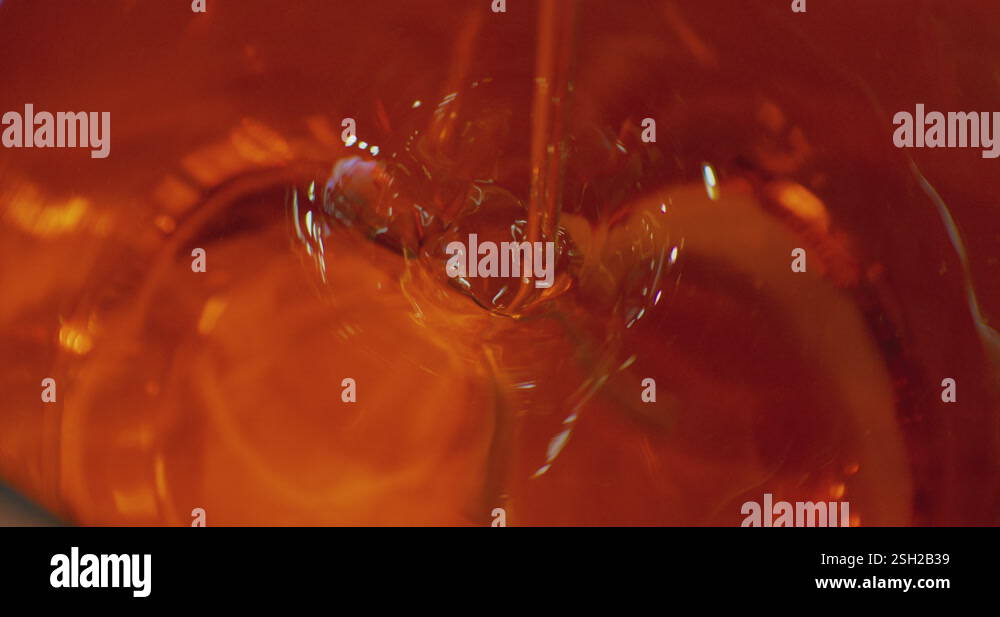 A mixer stirs a bright liquid in a glass beaker.Close-up Stock Video ...