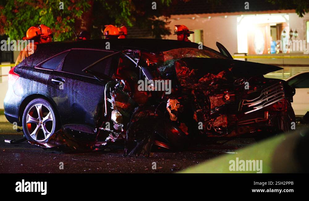 Firefighters at a crashed car at a accident scene, during nighttime ...