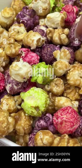multicolored popcorn sweet glaze, in bulk, selective focus, moving ...