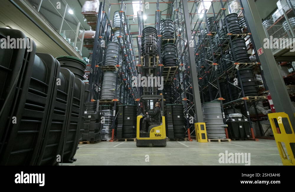 Forklift Driver Lifting Water Tank Onto Racking In Manufacturing ...