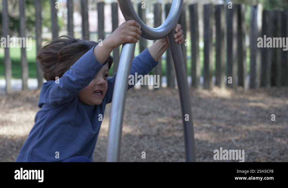 Child spinning at playground spinner structure. One little boy having ...