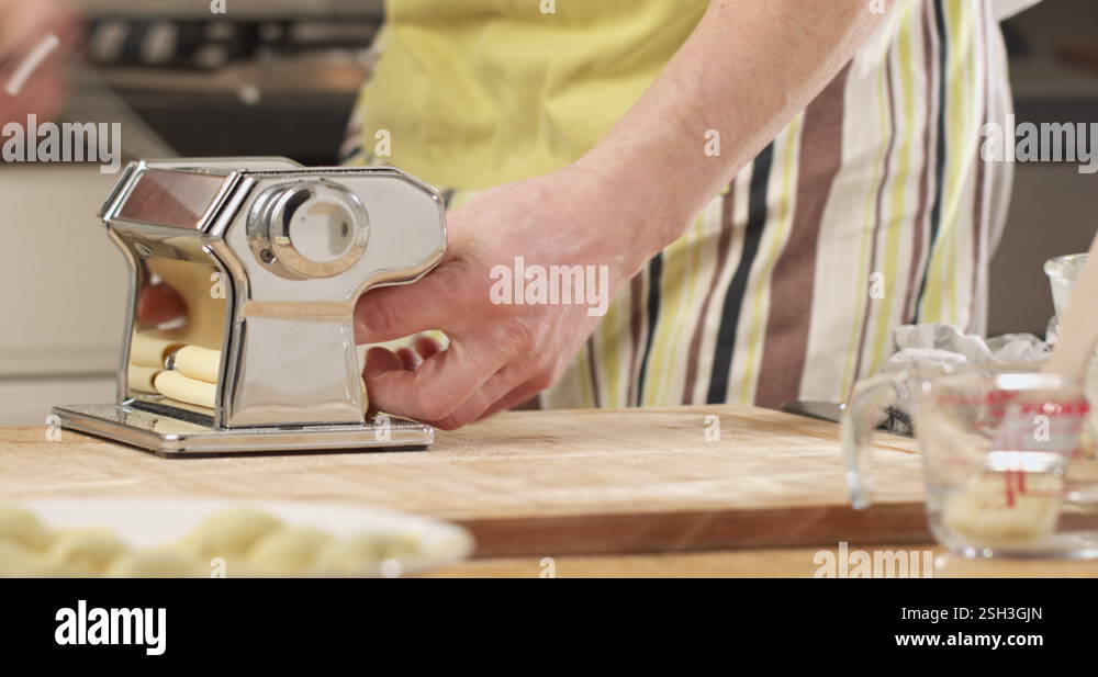 Making Ravioli - Male Home Chef Making Pasta Sheets on a Pasta Machine ...
