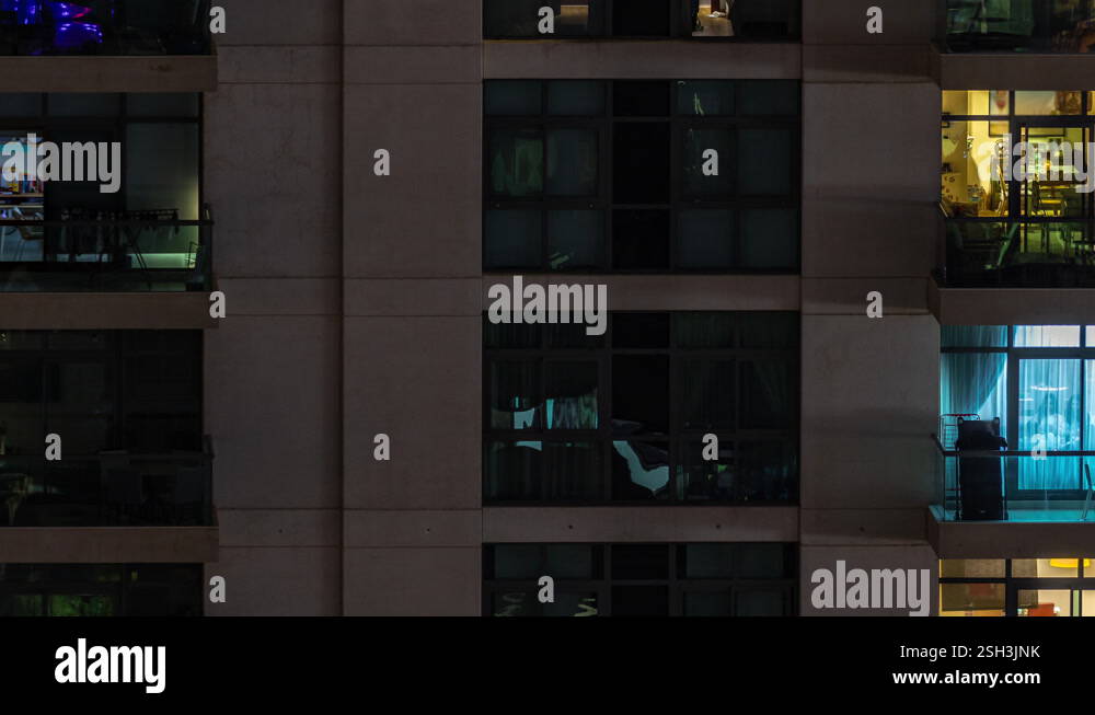 Windows of apartment building at night timelapse, the light from ...