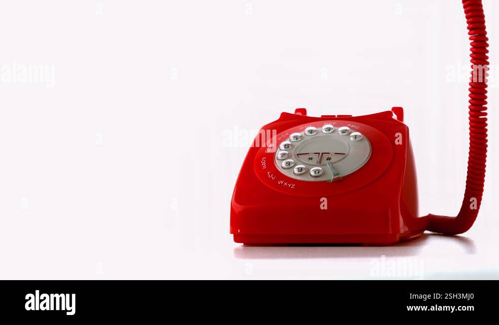 Receiver falling onto a red dial phone on white background Stock Video ...