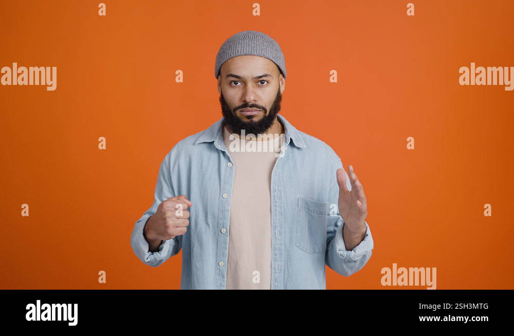 Man stares menacingly and hits palm with fist threateningly Stock Video ...