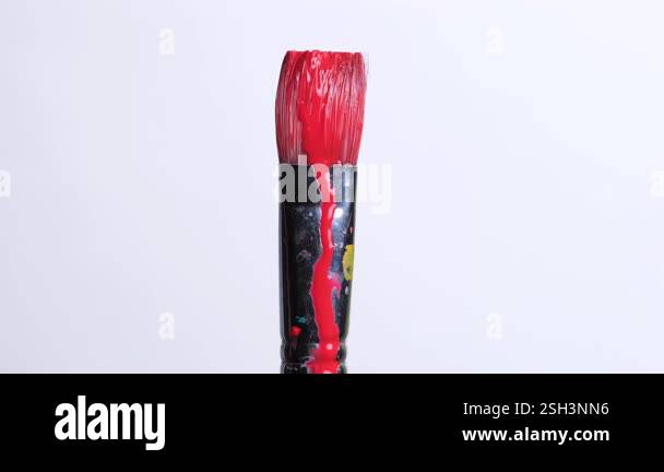 Red paint dripping from a paintbrush Stock Video Footage - Alamy