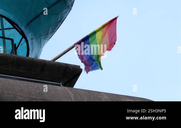 LGBTQ rainbow flag on a building Stock Video Footage - Alamy