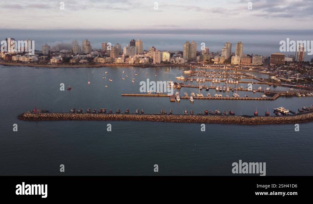 Punta del Este City Beach at sunset. Port area, boats and pier at ...