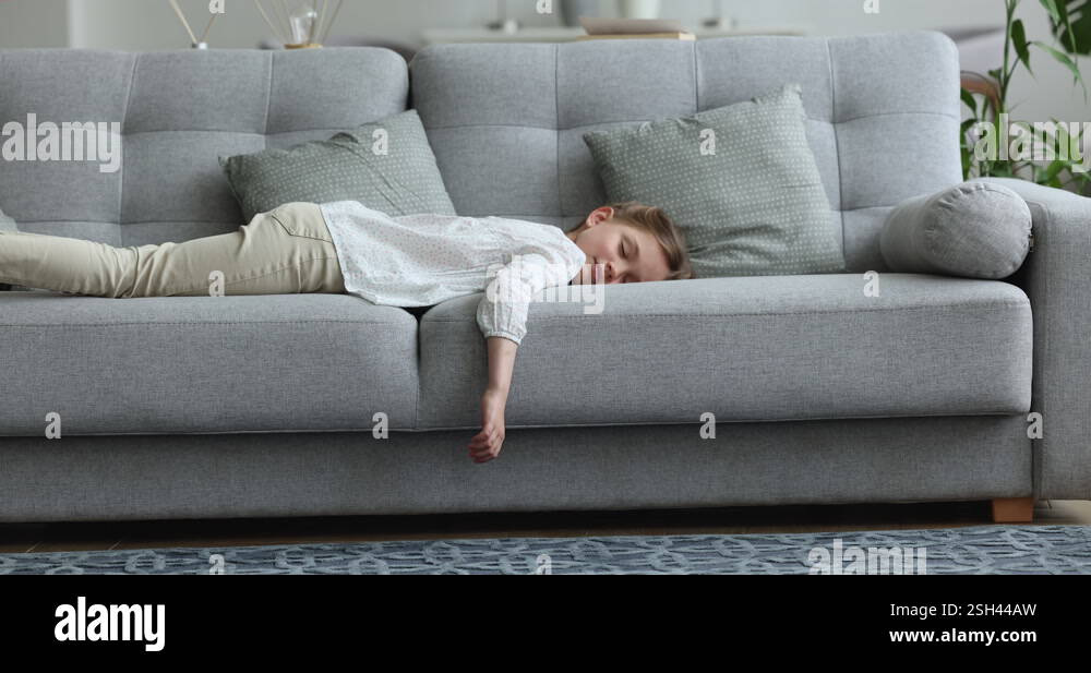 Girl came home after school and flopped down on sofa Stock Video ...