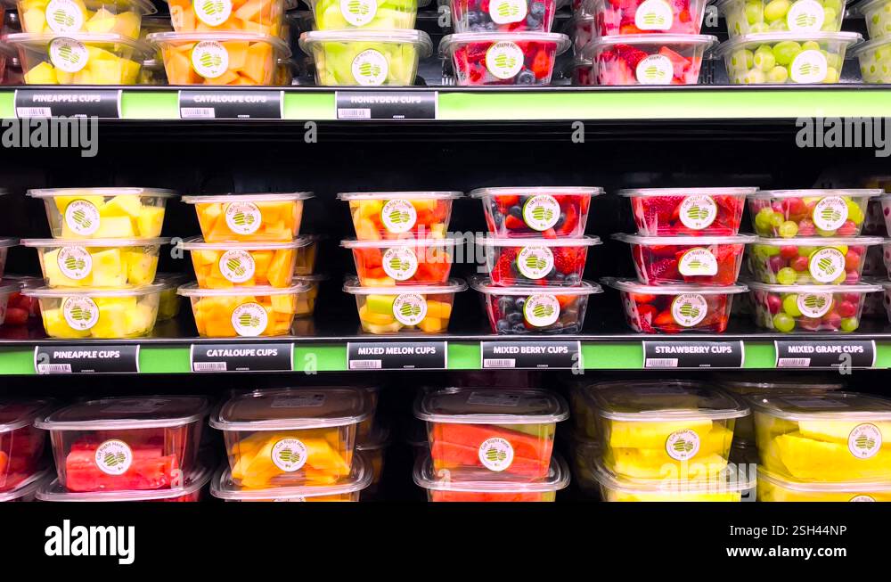 Fresh cut fruit in tubs on a grocery store shelf tilt down Stock Video ...