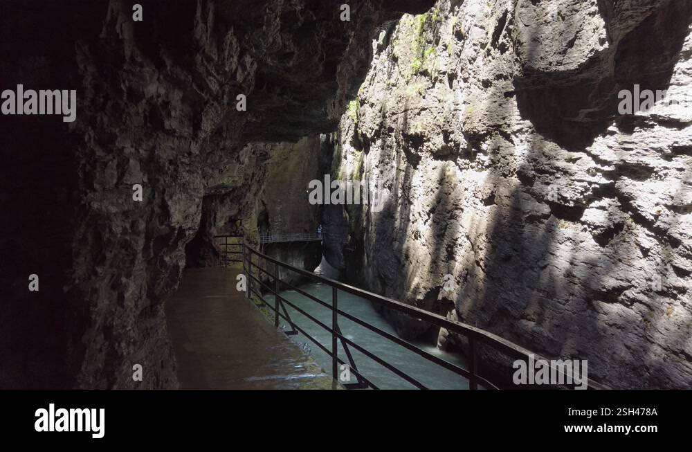 A walkway next to a river in a gorge of rocks. Aare gorge in the canton ...