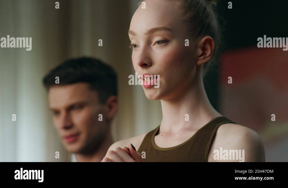 Girl training leg muscles with boyfriend doing squats together in room ...