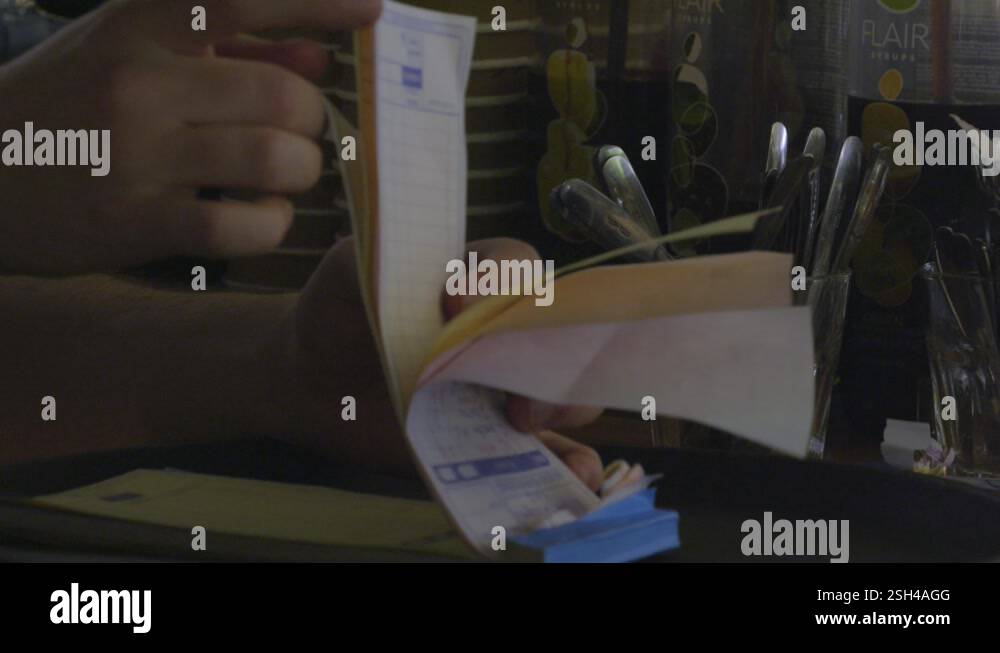 Man going through receipts in a bar Stock Video Footage - Alamy