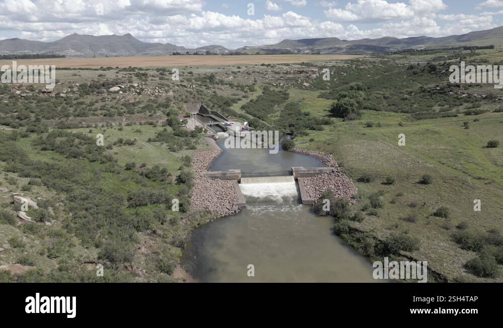 River pours over river weir at hydro dam underground pipeline outfall ...