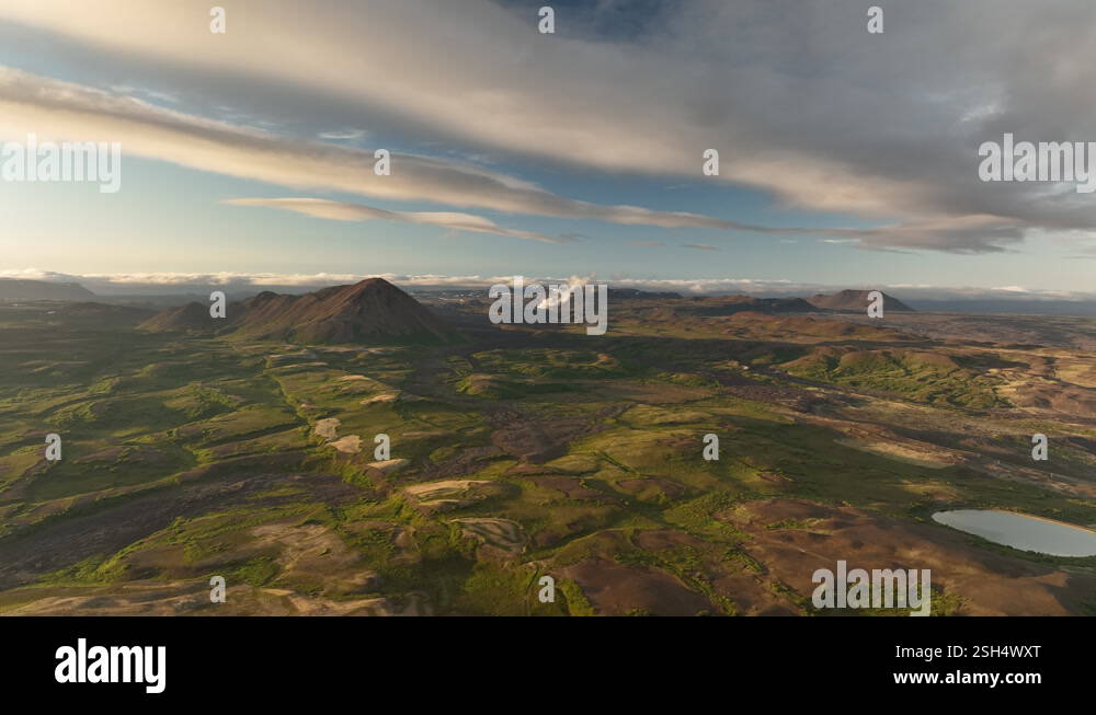 sunset over the volcanic hills and mountains with geological power ...