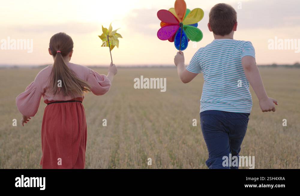 Concept of childrens play in nature. Happy children play with toy ...