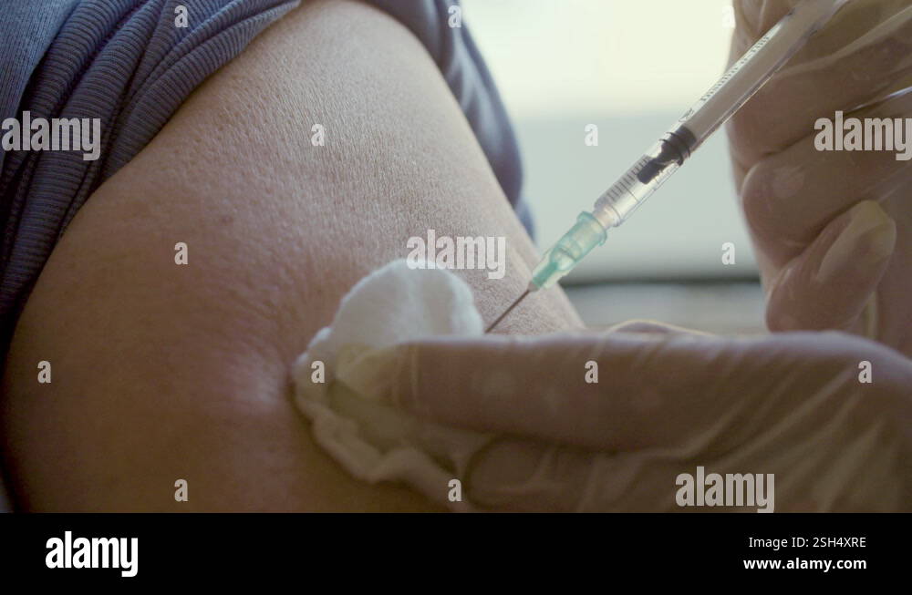 Close-up shot of syringe with injection inserting into arm Stock Video ...