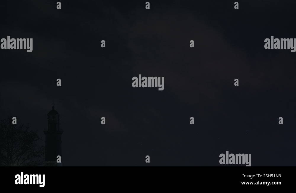 Blue light flashes through the lighthouse in the dark, Static shot ...