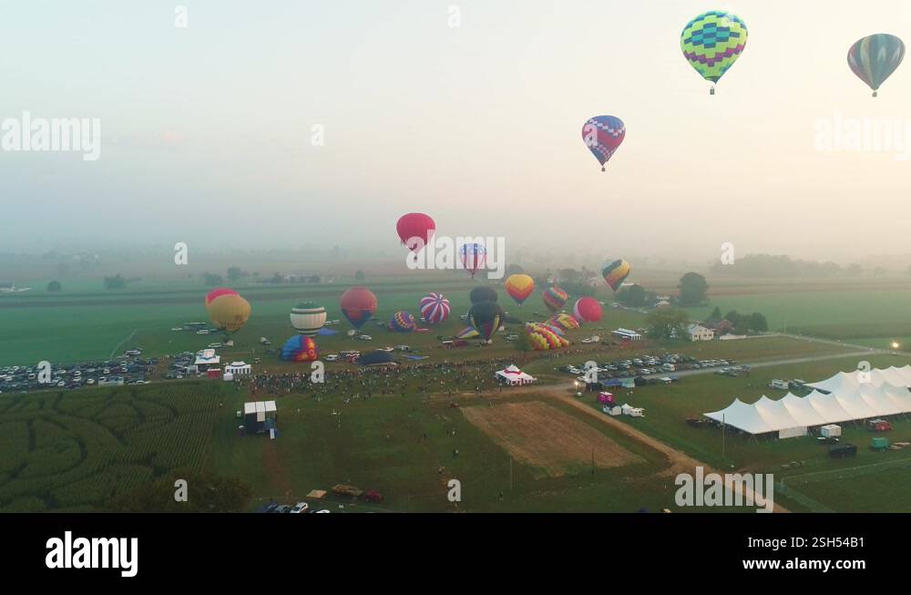 An Aerial View of Multiple Hot Air Balloons Rising into the Early Mist ...