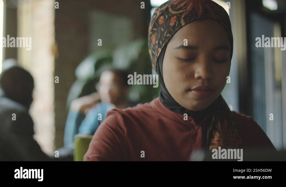 Muslim Woman Working on Laptop in Cafe Stock Video Footage - Alamy