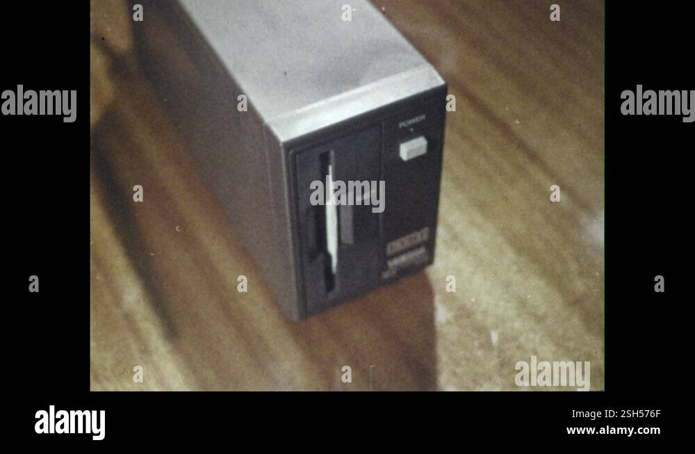 1980s: Hand places 3.25" floppy disk into hard drive. 5.25" floppy ...