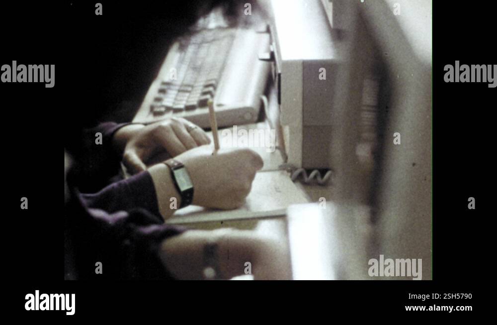 1980s: Hands write in notebook. Students take notes at computers in ...