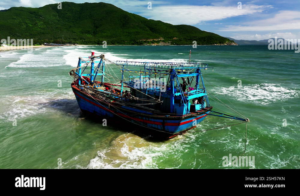 Fishing boat with a big catch of fish stranded with a catch, aerial ...