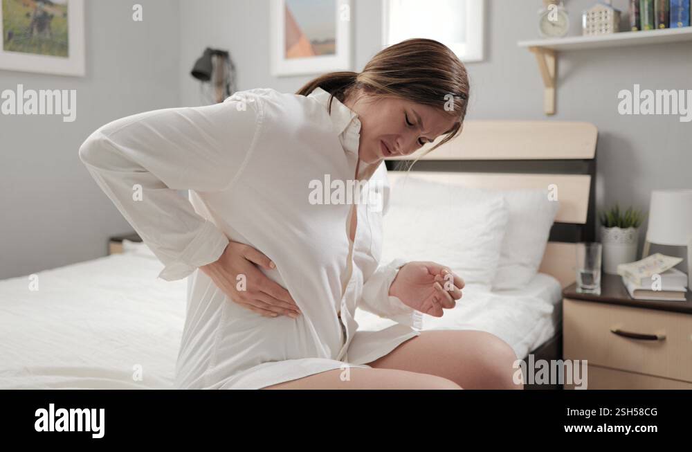 Pain in right side, liver disease. Young woman touching her right ...