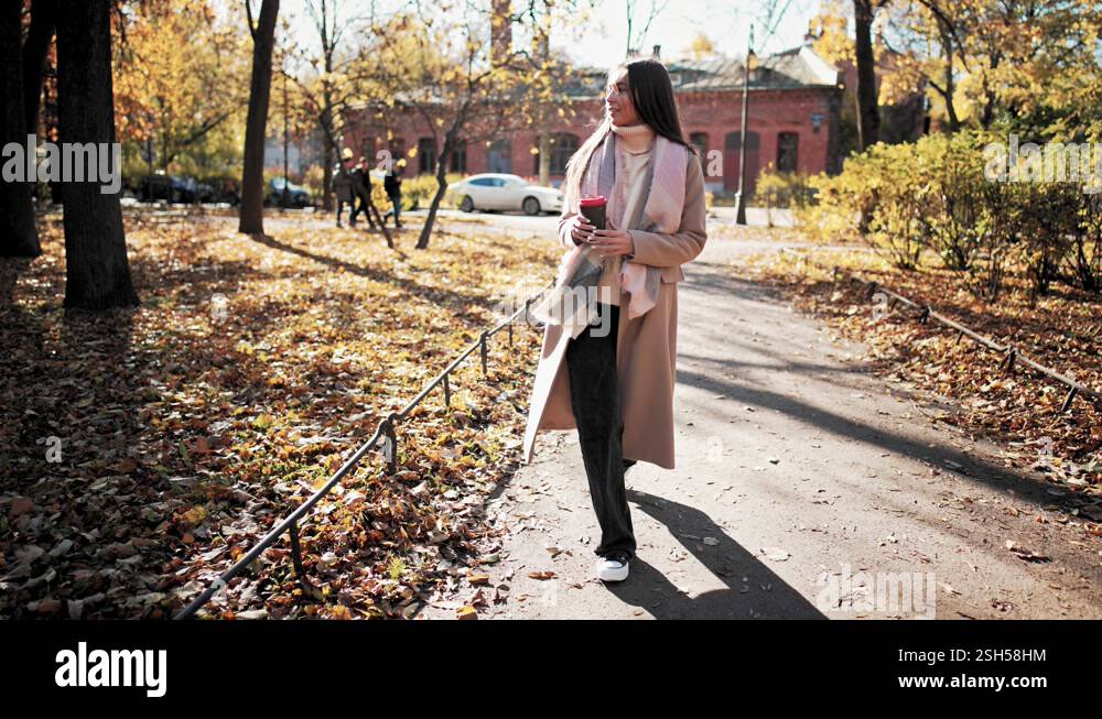 Full length front view young woman walking to camera with confident ...