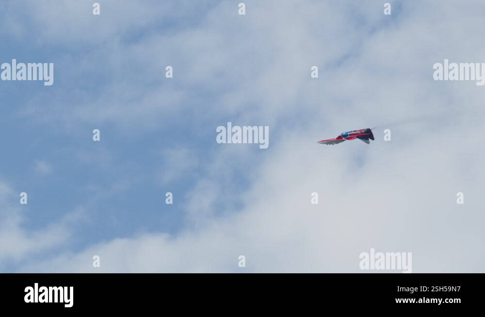 a Russian fighter plane painted blue and red flies in the sky Stock ...