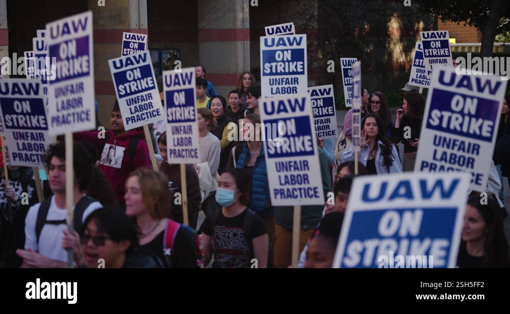 A Slow Motion Pan of a Large Crowd of Academic Workers with Signs ...