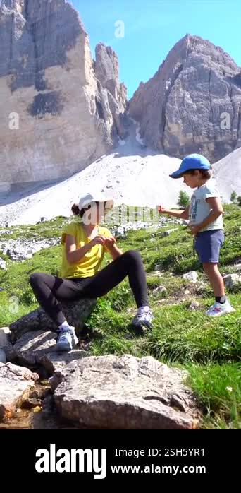 Mother and son enjoying hiking in the italian alps near tre cime di ...